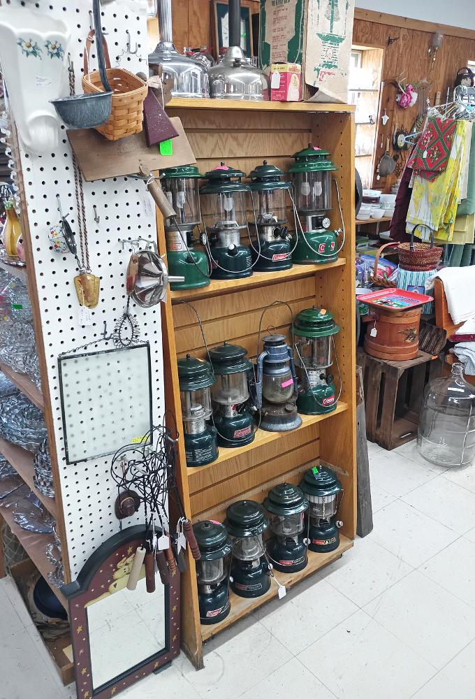 Coleman lanterns stand at attention like green soldiers of illumination, ready to light up camping trips and power outages with their reassuring hiss and glow.