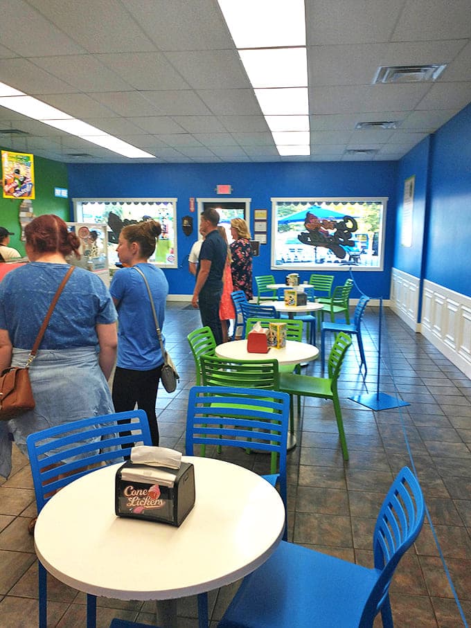 The bright blue walls and cheerful green chairs create a happy backdrop for ice cream enthusiasts plotting their next flavor conquest.