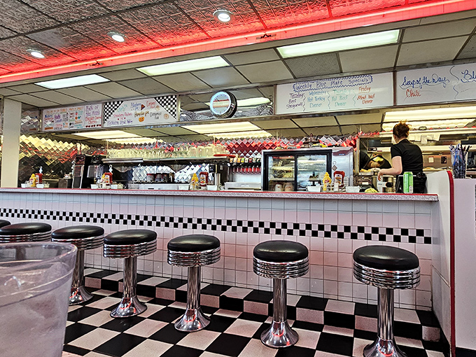 The counter where strangers become friends, coffee cups are never empty, and life's problems seem solvable between bites of toast.