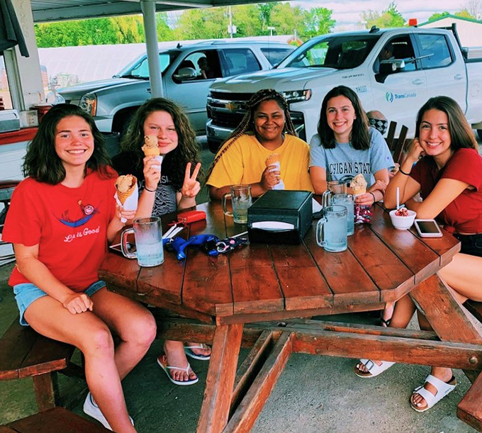 Summer memories in the making: Happy customers enjoying ice cream treats at Mishler's outdoor seating, where food brings people together.