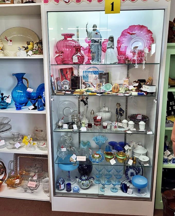 Delicate treasures in pink and blue glass catch the light like memories crystallized, each piece a survivor from more elegant times.