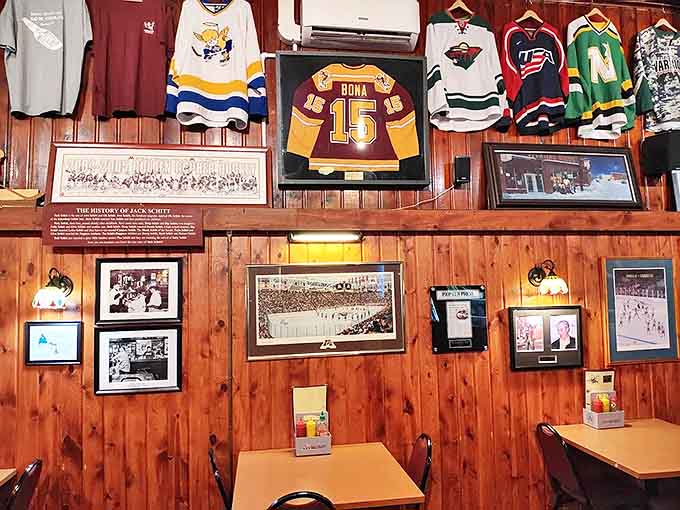 Hockey jerseys and sports memorabilia transform the walls into a Minnesota sports museum, with Goldy Gopher watching approvingly over diners.