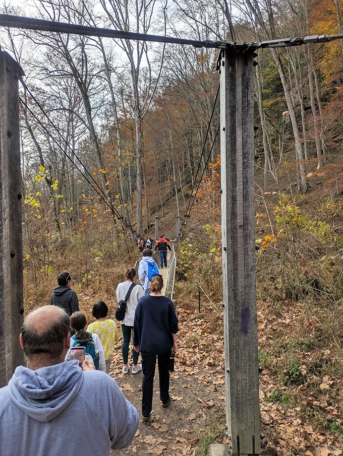 The suspension bridge becomes a community experience as hikers queue up for their turn to cross &ndash; shared adventure creates instant camaraderie.