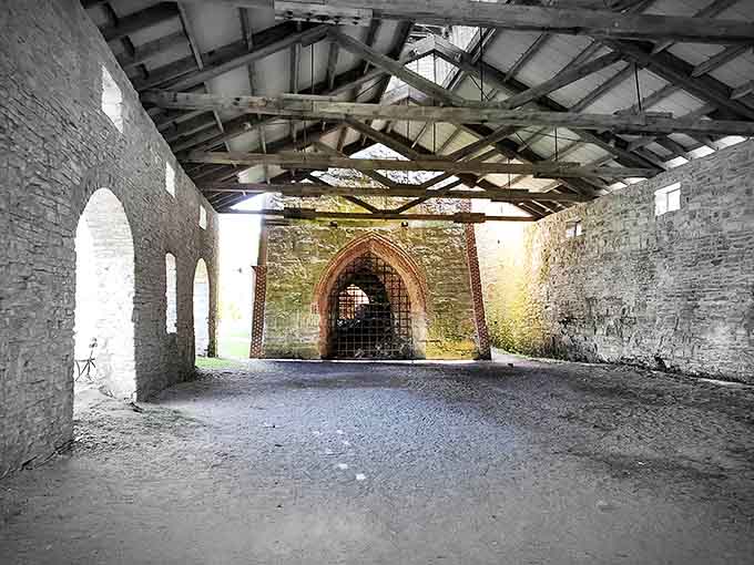 Sunlight streams through arched openings, nature's spotlight illuminating spaces once filled with the clamor of industrial production.