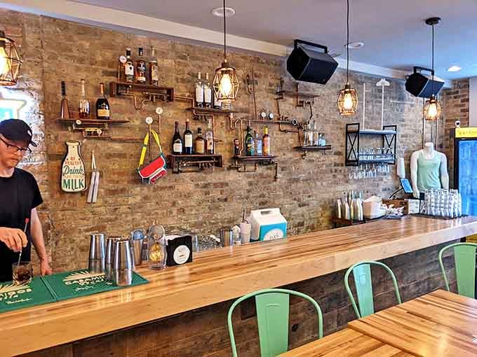 The bar area features exposed brick, industrial-chic shelving, and everything needed to create both boozy and zero-proof liquid desserts.