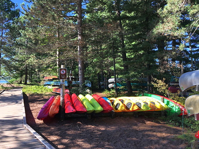 A rainbow armada of kayaks stands ready for adventure &ndash; each one a ticket to explore Big Bay's hidden corners.