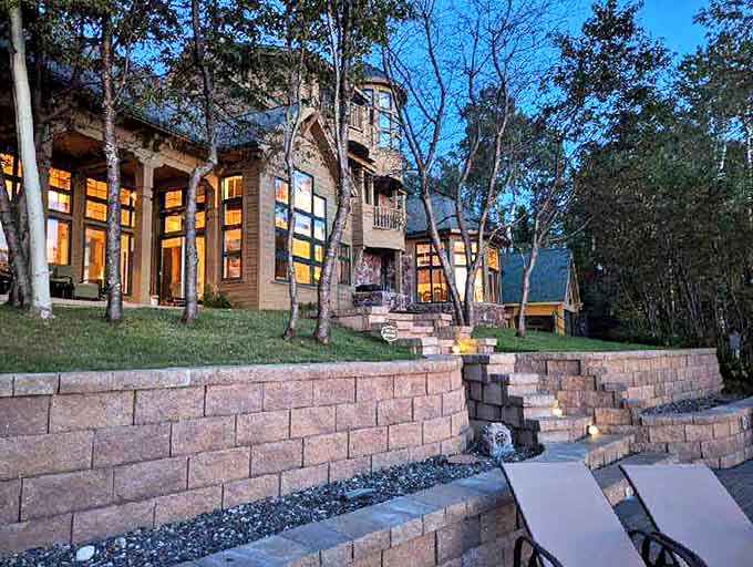 Evening transforms the castle into a glowing sanctuary, its illuminated windows promising warmth and comfort after a day of outdoor adventures.