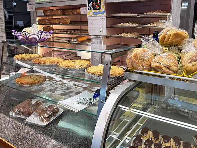 Behind glass fortresses, pastry treasures await rescue by hungry customers who've abandoned all dietary restraint.