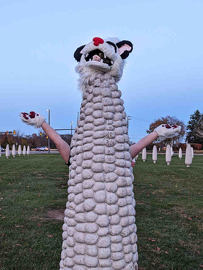 Halloween brings creative costumes to the corn field, with this visitor turning a concrete cob into an impromptu puppet show that delights passersby.