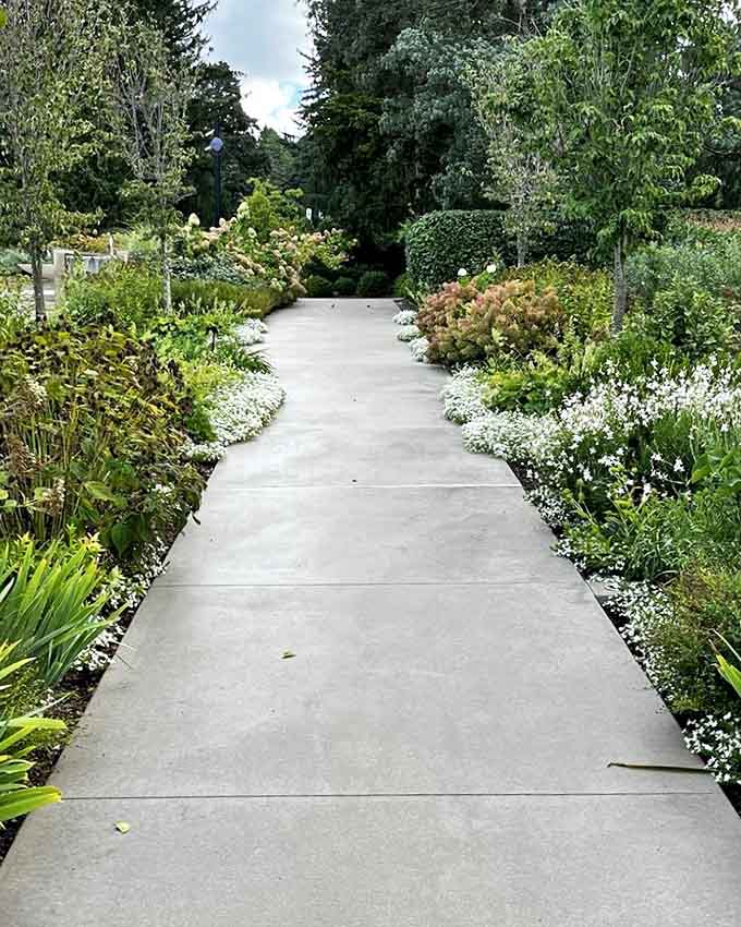 Paved walkways wind through meticulously maintained gardens, making accessibility and beauty walk hand in hand through the grounds.
