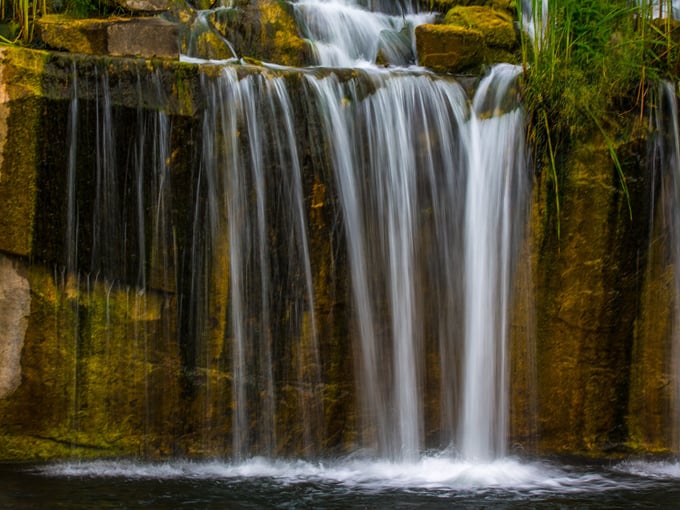 Silky water cascades create a hypnotic display, inviting visitors to pause and appreciate the therapeutic sound of falling water.