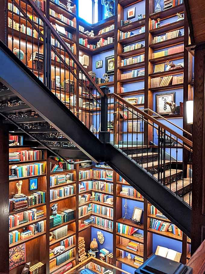 Beauty and the Beast would approve of this multi-level library where wooden staircases wind through literary treasures stacked floor to ceiling.