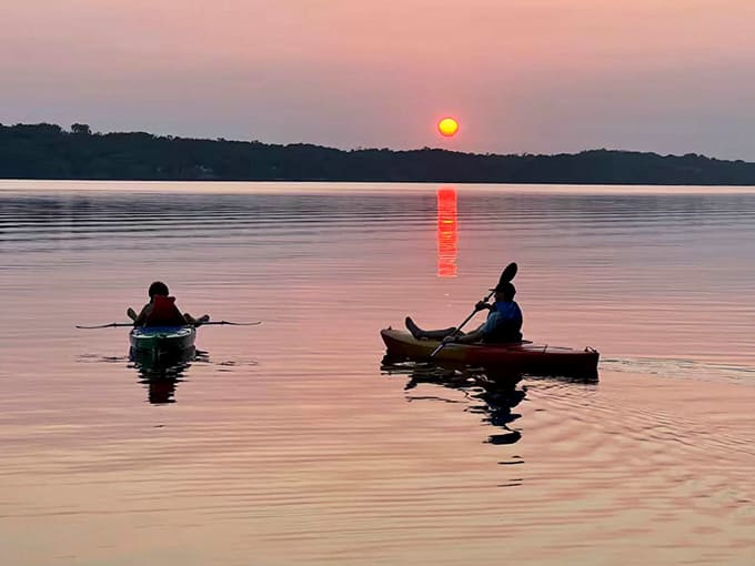 Kayaking at sunset on Big Stone Lake – where Minnesota magic happens and everyday worries dissolve into ripples of orange-gold water.
