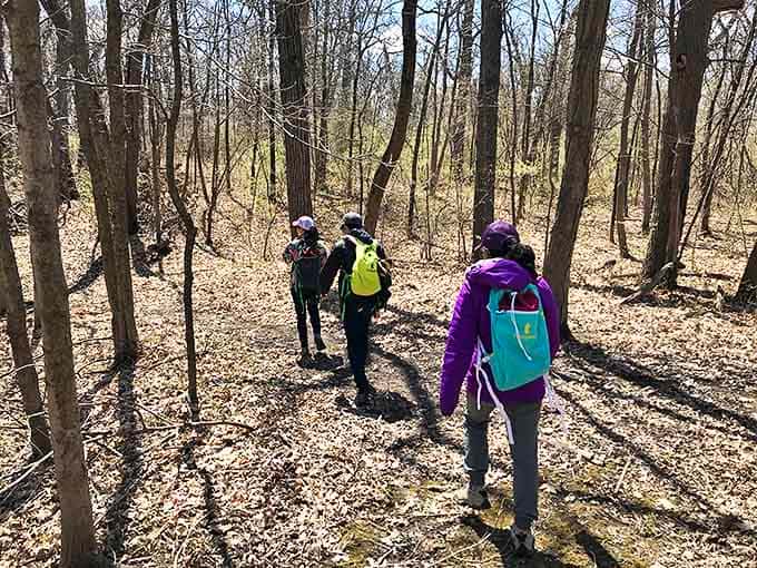Explorers traverse the wooded trails at Lehigh Memorial Park, where former quarry lands have transformed into a peaceful natural retreat.
