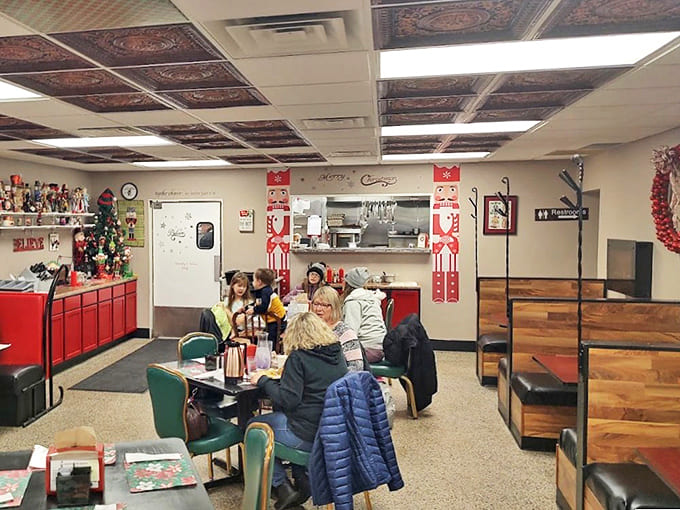 The dining area balances festive charm with cozy functionality, where holiday decorations create warmth rather than distraction.