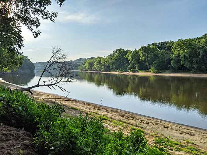 The mighty Mississippi flows with casual majesty, its sandy banks offering a perfect pause point for riverside contemplation.