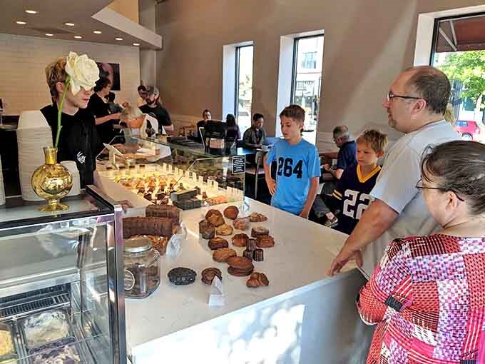 The pastry pilgrimage in action – locals and visitors alike drawn to the glass case like moths to a buttery, sugar-dusted flame.