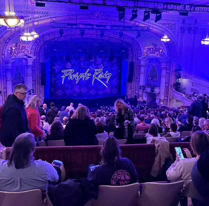 The anticipation builds as theater-goers mingle in the ornate corridors, a social ritual that's been happening here for a century.