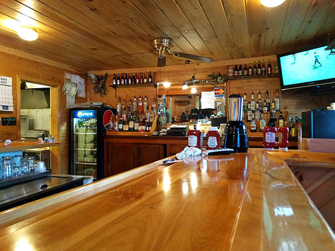 The welcoming bar area gleams with polished wood, offering a selection of local brews and classic cocktails perfect for unwinding after a day on the lake.
