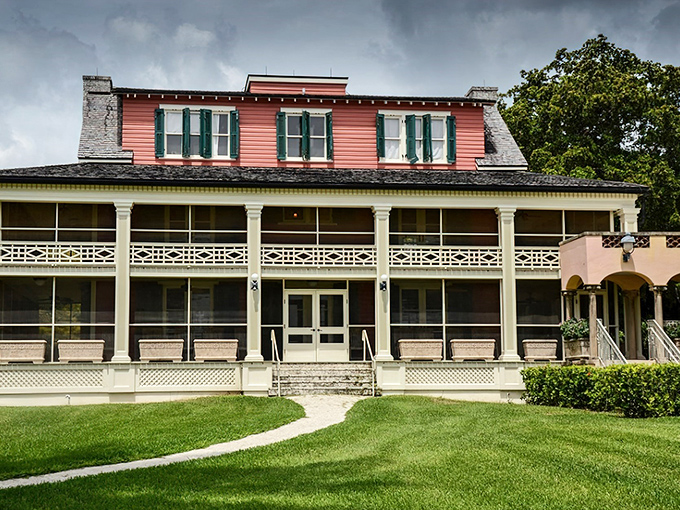 Richmond Cottage's distinctive coral-colored roof peeks through white columns, offering a more relaxed counterpoint to Stone House's formality.