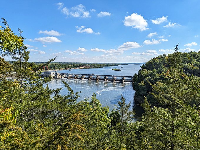 Engineering meets nature as the dam creates a perfect horizontal line against the river's organic flow.