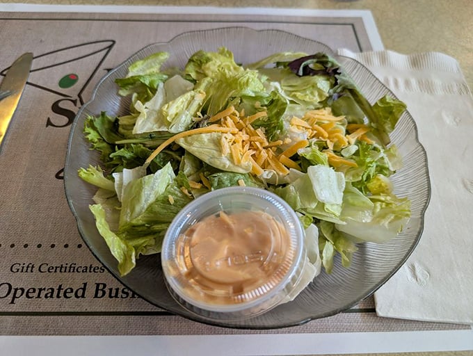 A fresh garden salad topped with shredded cheese, the perfect light starter before diving into the hearty main courses that await.