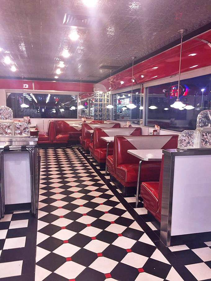 The dining area's red vinyl booths aren't just seating – they're front-row tickets to a show that's been running continuously since Elvis was king.