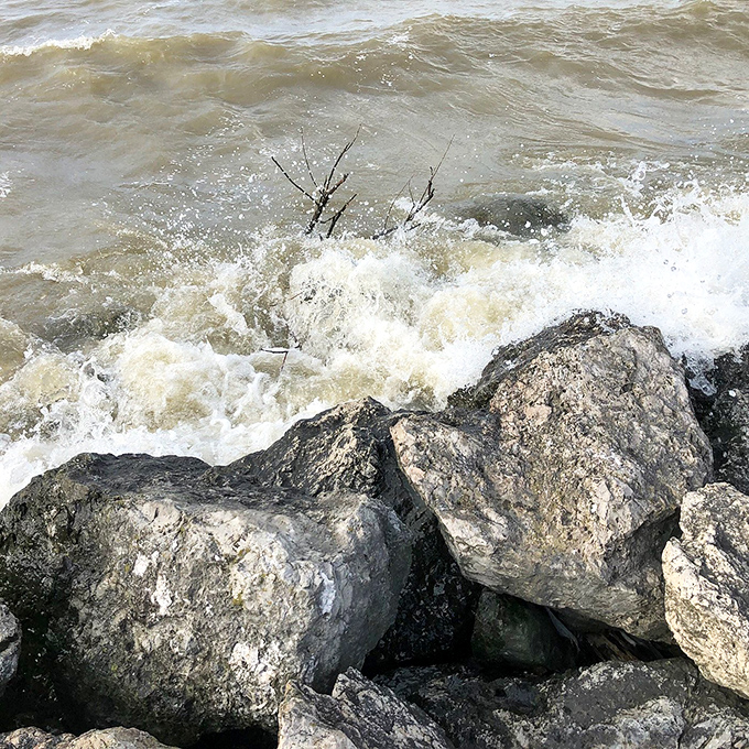 Small Waves: Lake Erie's waters crash dramatically against the breakwall rocks, proving the Great Lakes can deliver oceanic drama when provoked.