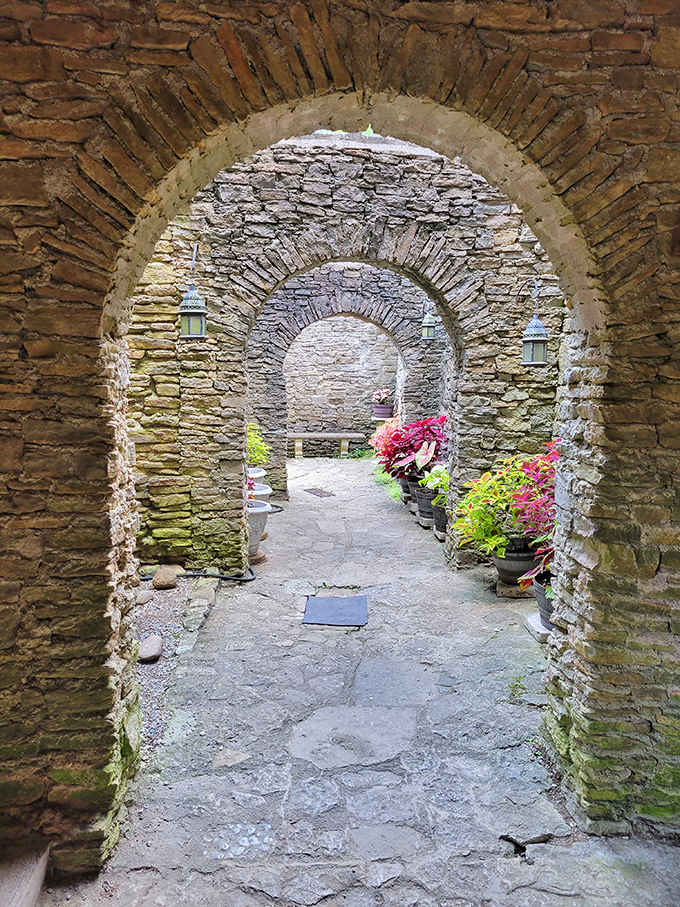 Arched stone corridors create perfect frames for exploration, drawing visitors deeper into this medieval Ohio wonder.