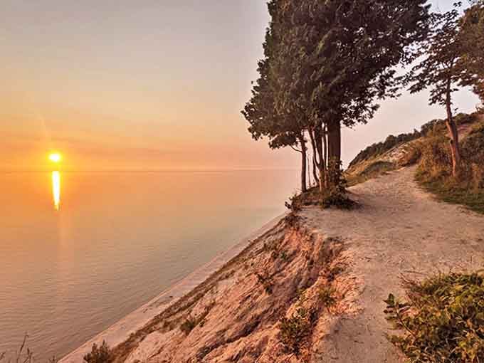 Magic hour transforms the lakeshore into liquid gold, where the path seems to lead directly into a perfect Michigan sunset.