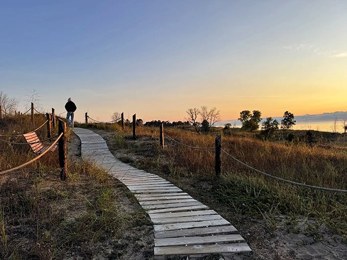 A solitary figure contemplates the sunset from the boardwalk &ndash; sometimes the best companions are silence and beauty.