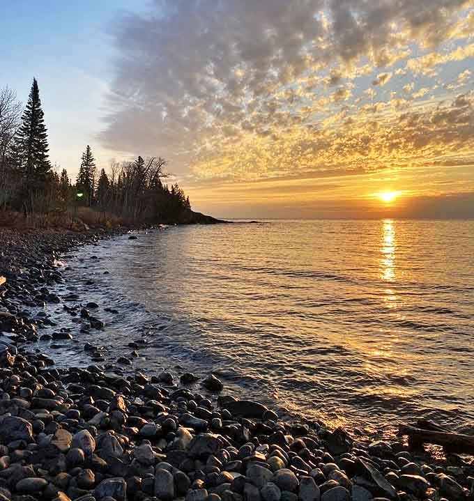 Sunset transforms Lake Superior into liquid gold, a spectacle that makes you forget your burning calves and blistered heels.