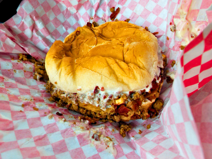 The Chili Cheeseburger in its natural habitat &ndash; a red-checkered wrapper barely containing this magnificent mess of flavors.