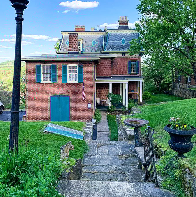 The Inn at Felt Manor showcases Victorian splendor with its distinctive patterned roof and blue accents.