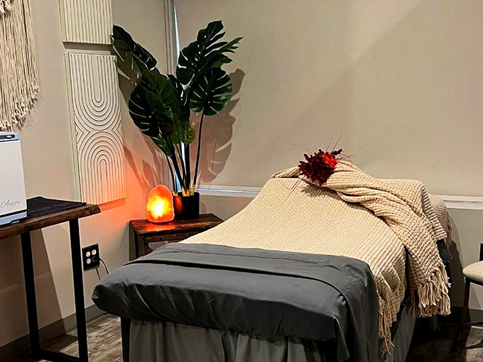 The massage area features natural elements and salt lamps that maintain the spa's serene aesthetic throughout.