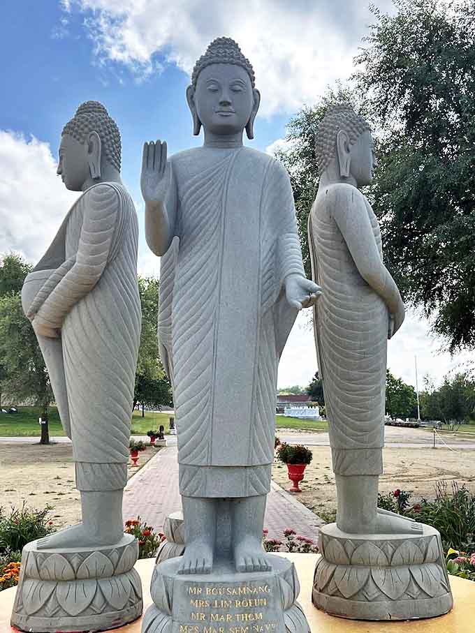 Three's company: these standing Buddha statues create a powerful presence in white stone, their different hand positions speaking volumes without saying a word.