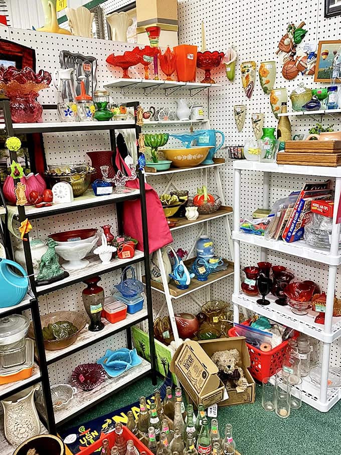 A rainbow of vintage glassware catches the light, each piece holding memories of cocktail parties and family dinners from decades past.