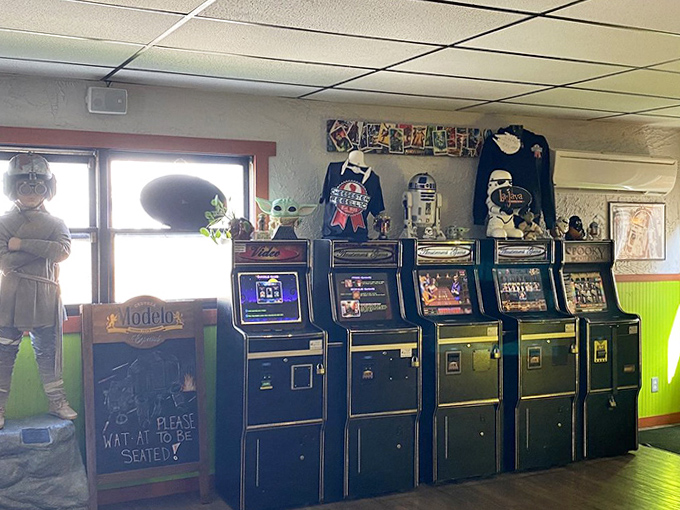 The arcade corner offers entertainment while you wait – though good luck tearing yourself away once you start playing.