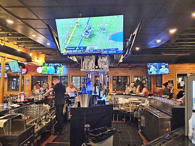 Bartenders craft drinks with practiced efficiency beneath an impressive array of screens &ndash; sports heaven with libations.