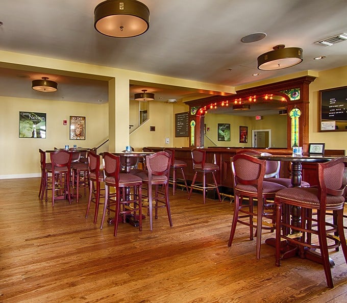The theater's bar area offers a perfect spot for pre-show conversations, its warm wood tones and soft lighting encouraging connections.