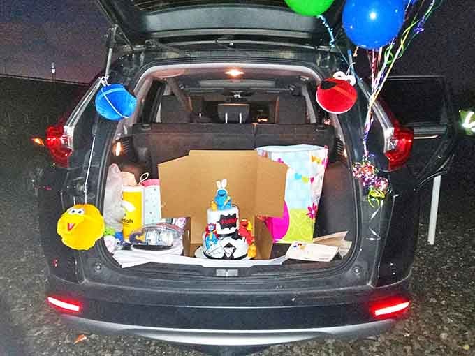 Birthday celebrations take on special magic at the drive-in, with decorated trunks, balloons, and cake served under the stars.