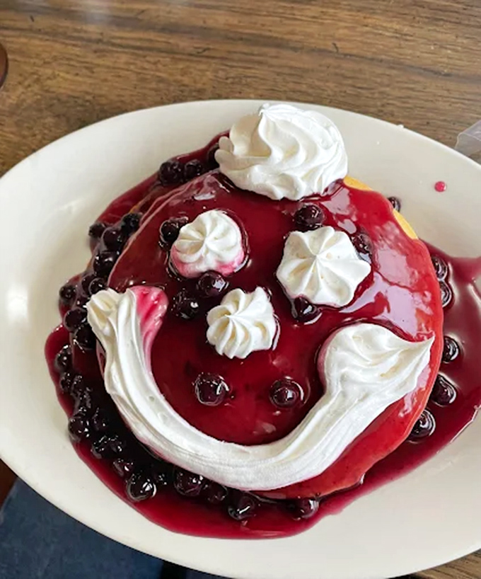 Blueberry pancakes crowned with whipped cream &ndash; a smile-inducing creation that proves happiness can indeed be found on a plate.