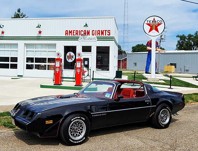 Classic cars complement the vintage vibe, with this pristine Trans Am parked perfectly beside the museum's authentic Texaco pumps.