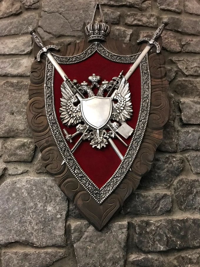 Heraldic shields and medieval weaponry adorn the castle walls, showcasing the commitment to thematic authenticity throughout the property.