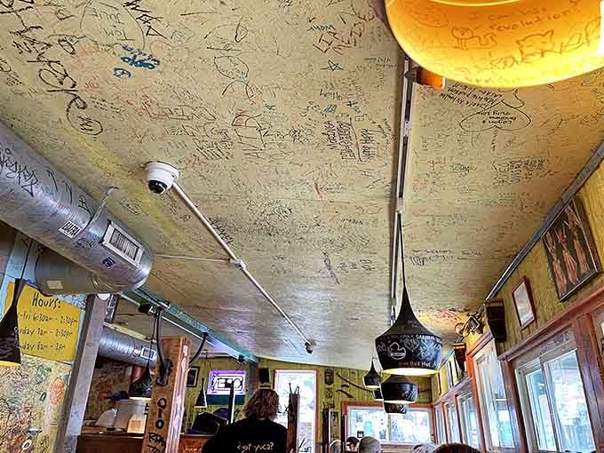 Look up! The ceiling serves as a guest book where visitors have left their mark for decades.