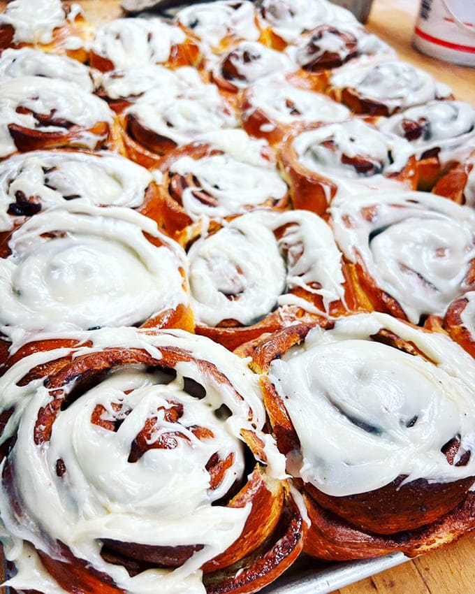 Cinnamon rolls dripping with cream cheese frosting create a scene that should probably come with a warning label for people trying to watch their sugar intake.