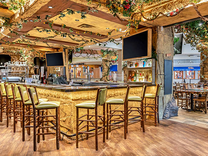 Bar seating offers front-row views of mixologists crafting jungle-inspired libations, perfect for weary shoppers needing liquid courage for the next store.