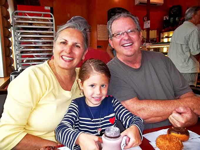Happy customers enjoying their bakery finds &ndash; the universal expression of people who've discovered one of life's simple, perfect pleasures.