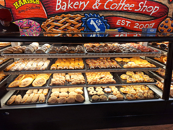 Rows upon rows of freshly baked delights create a panorama of pastry perfection that makes choosing just one nearly impossible.
