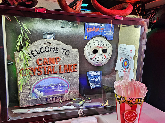
A shrine to Friday the 13th's Jason Voorhees sits among horror memorabilia, celebrating cinema's most infamous camp counselor.